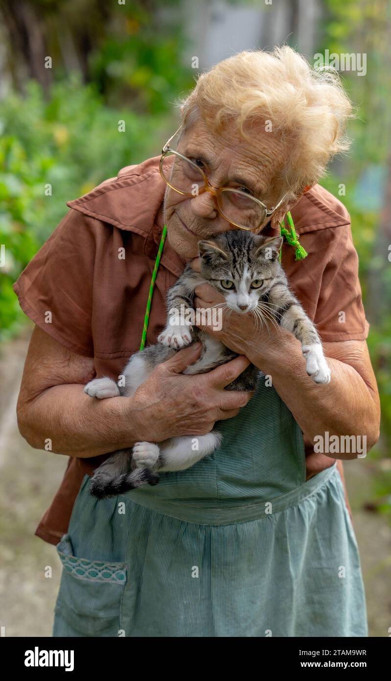 Old lady with cat Stock Photo - Alamy