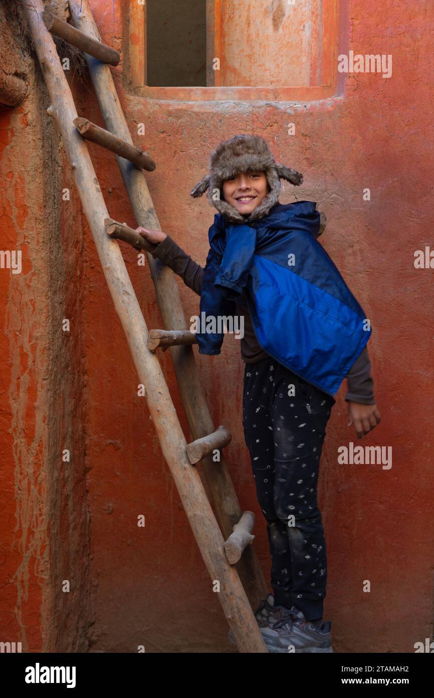 Vajra Garrett on a ladder in Yara village - Mustang District, Nepal ...