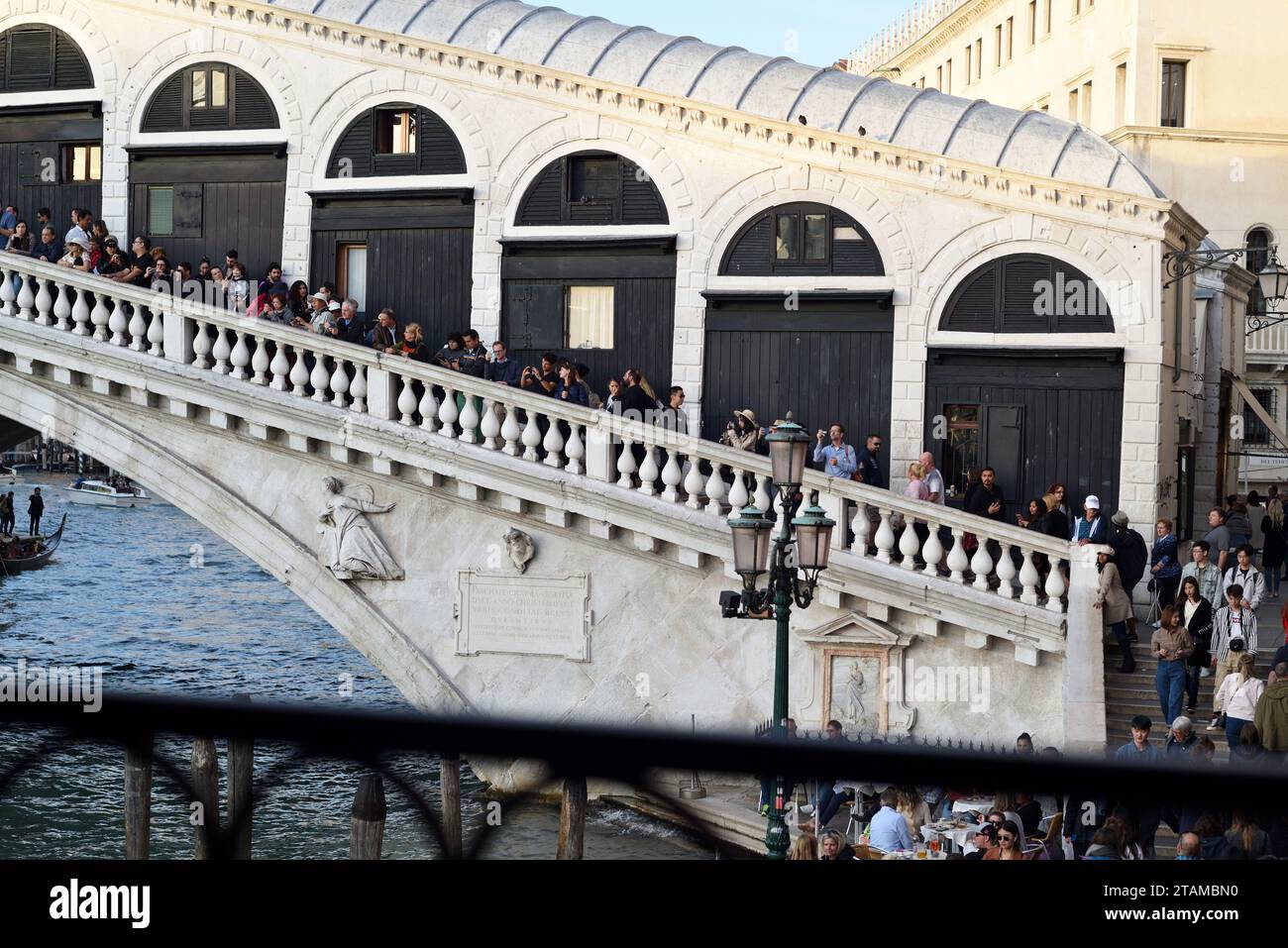Overtourism in Venice as rows of tourist line the steps and railing of ...