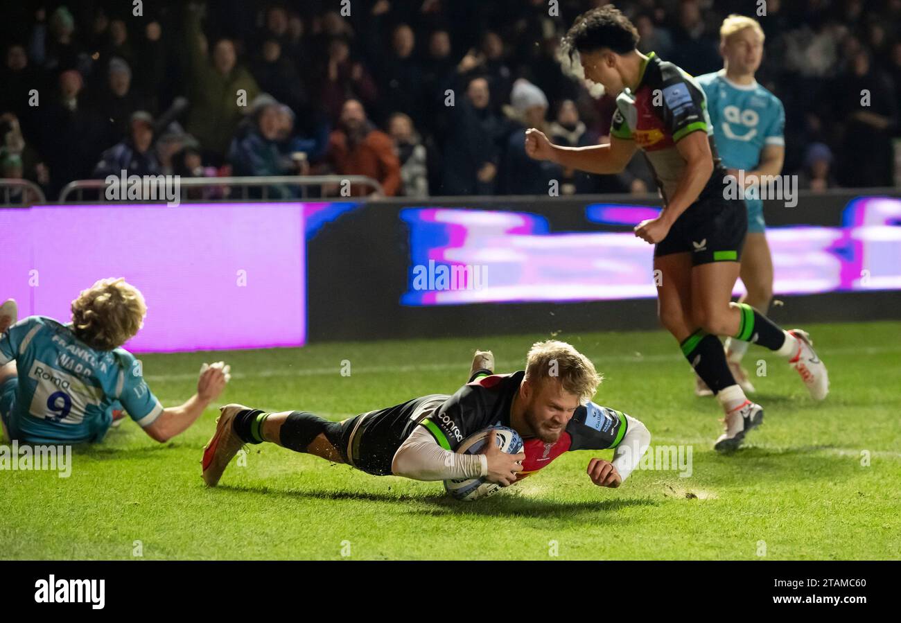 Harlequins Tyrone Green goes over for the first try with Marcus Smith ...