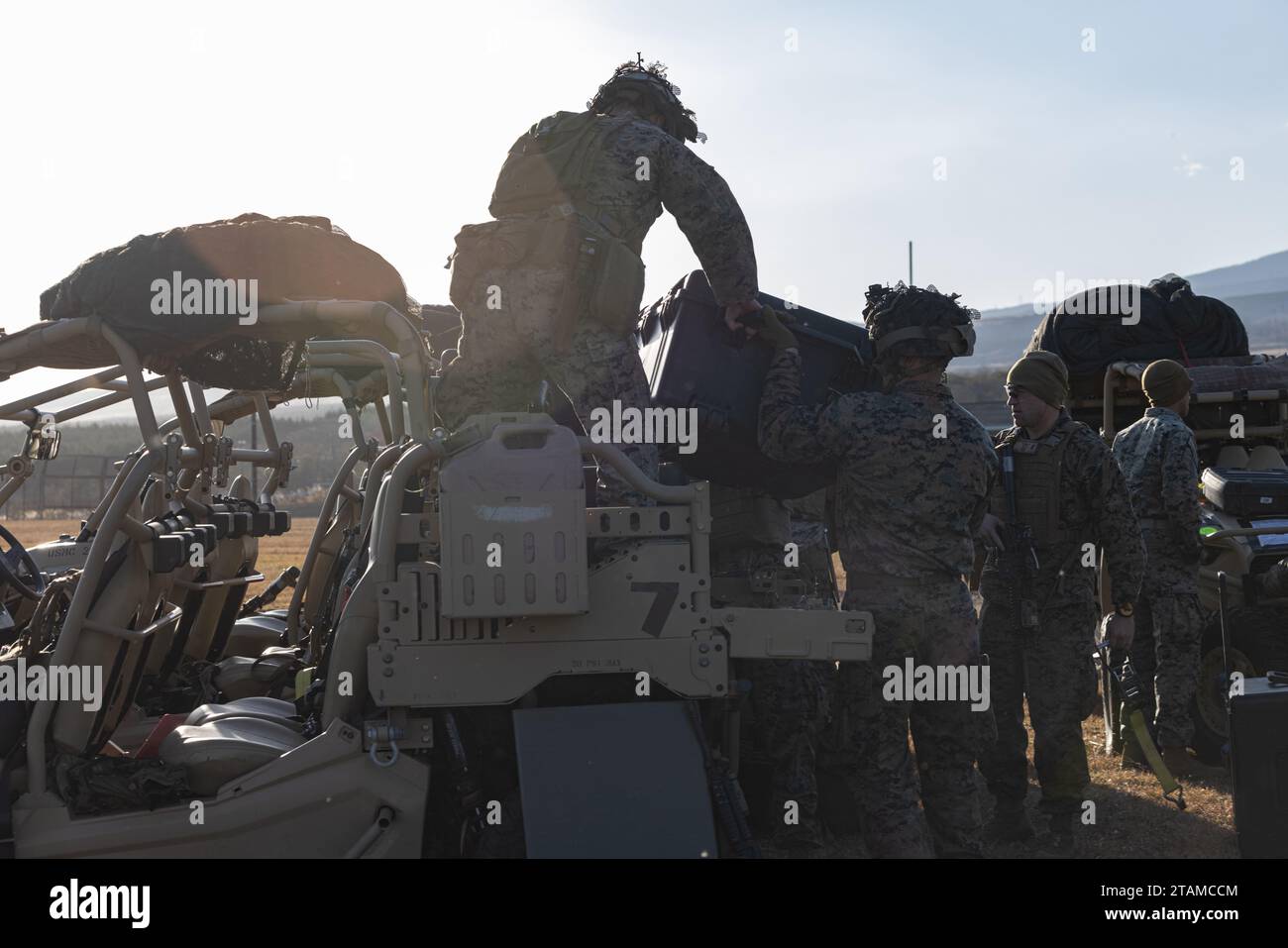 U.S. Marines unload a Marine Corps utility task vehicle in preparation ...