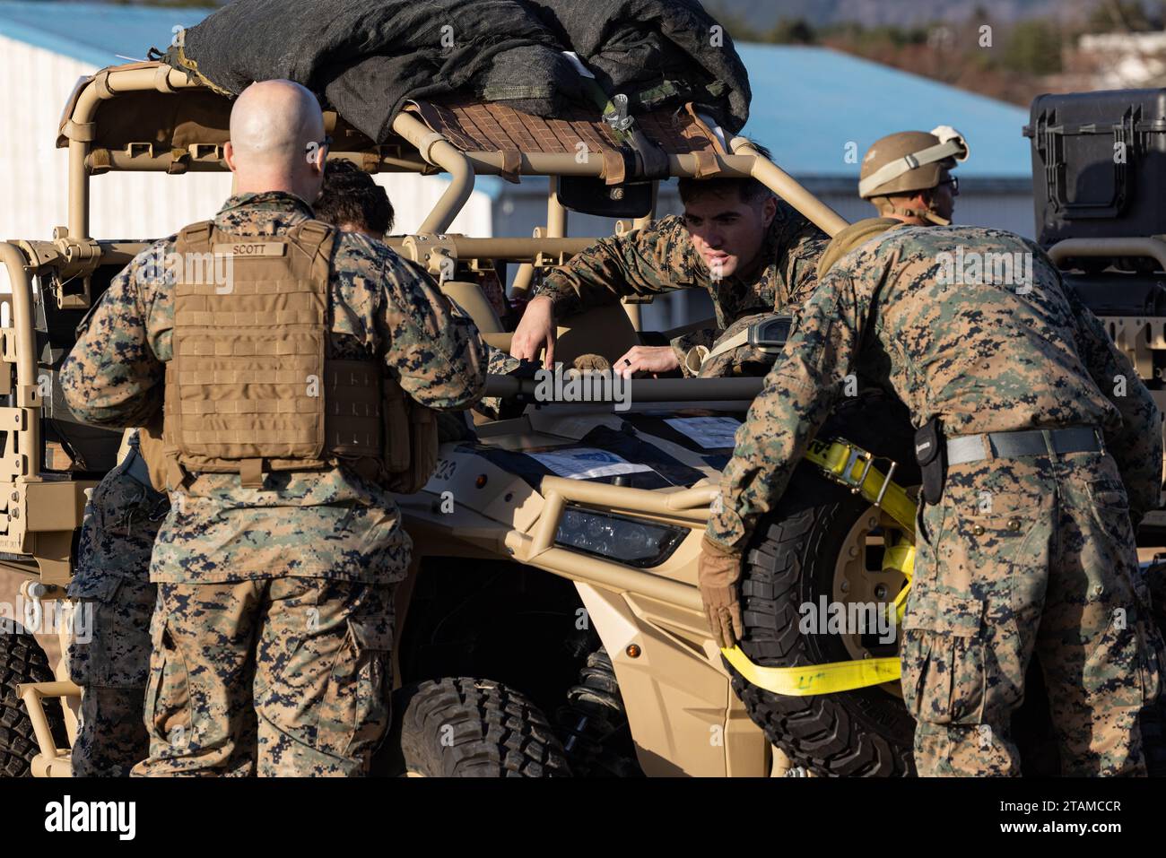 U.S. Marines unload a Marine Corps utility task vehicle in preparation ...