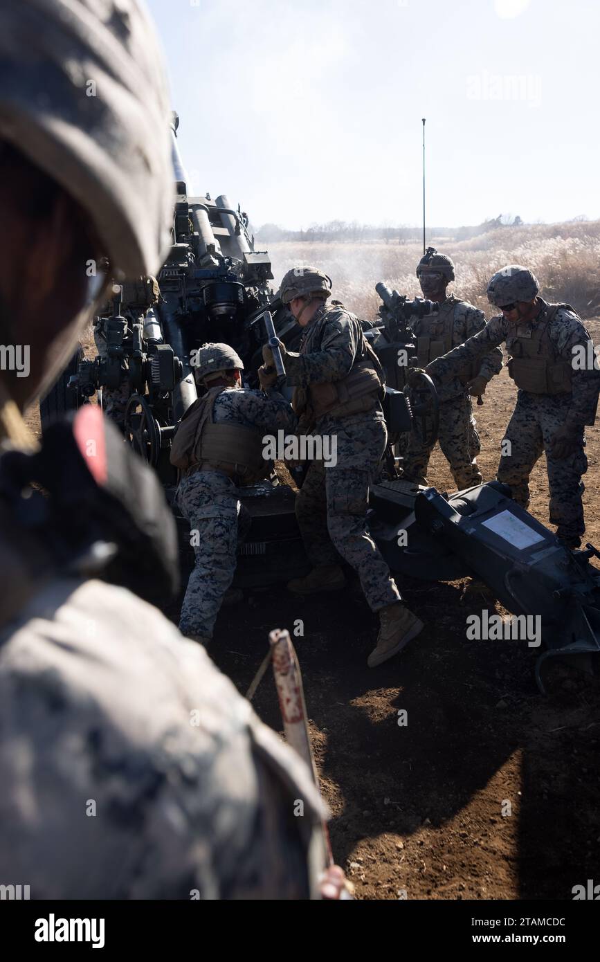 U.S. Marines use a ramming staff to set a round in an M777 Howitzer during Artillery Relocation ...