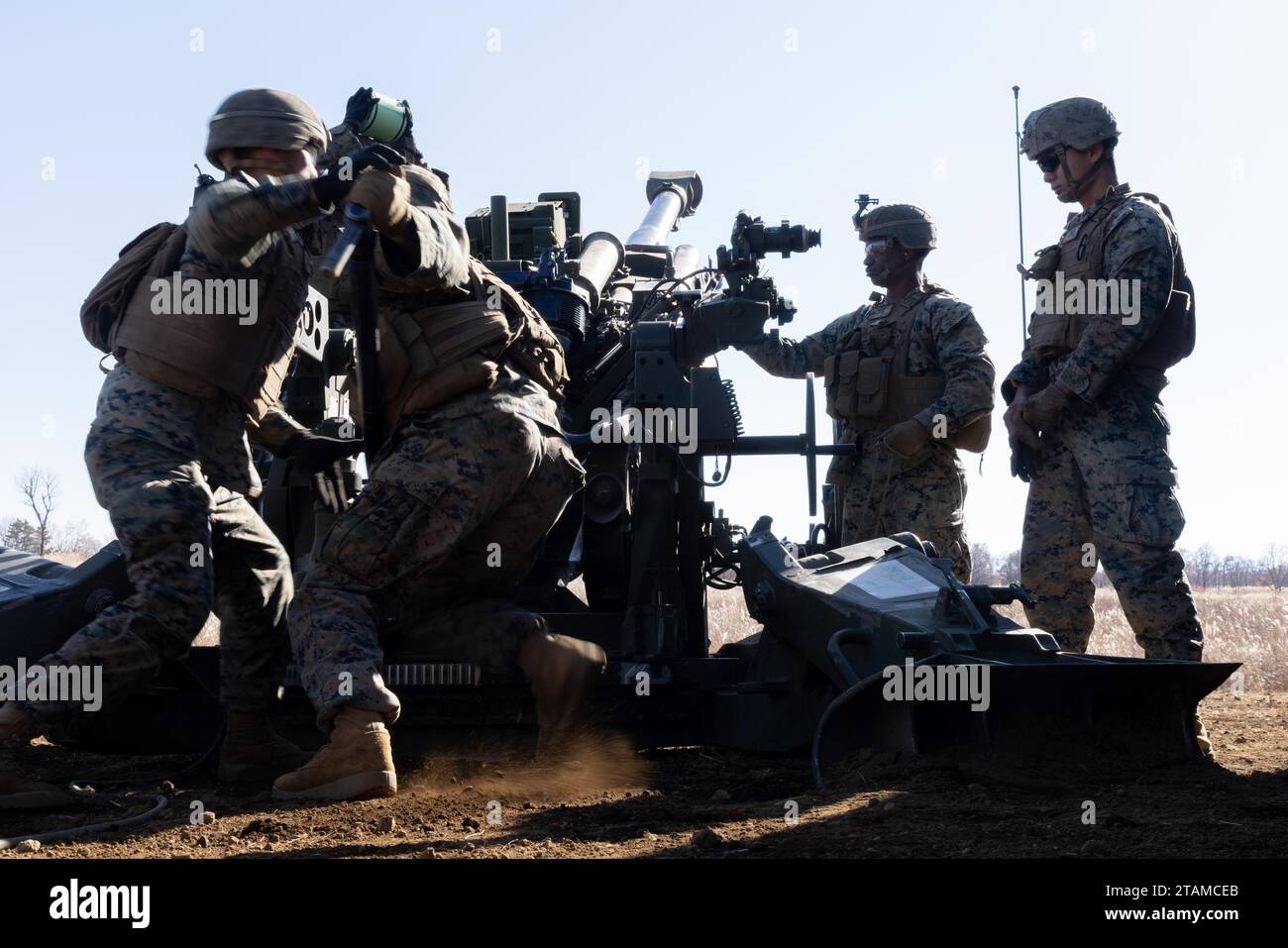 U.S. Marines use a ramming staff to set a round in an M777 Howitzer during Artillery Relocation ...