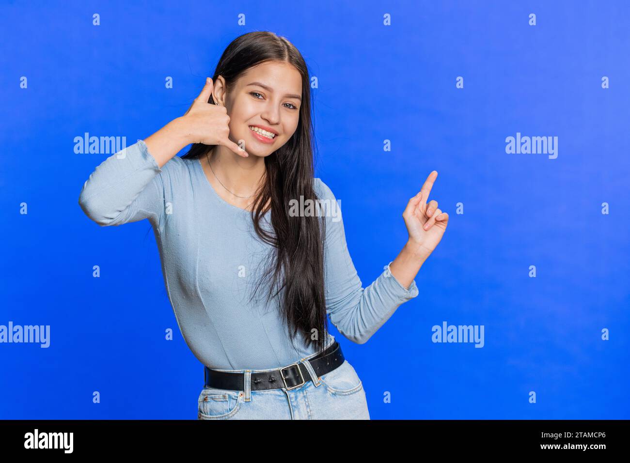 Call me, here is contact number. Caucasian young woman looking at ...