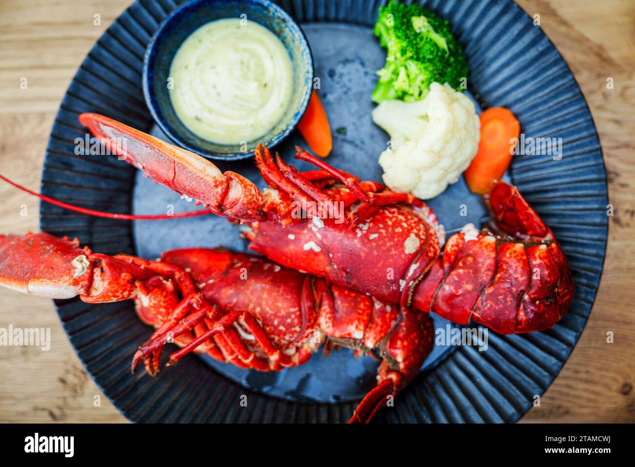Gourmet Red Lobster Halves Plated on Elegant Black Dish in Fine Dining ...