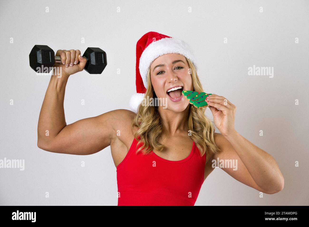 Female Bodybuilder Brawny Holding Dumbbell Eating Christmas Cookie ...