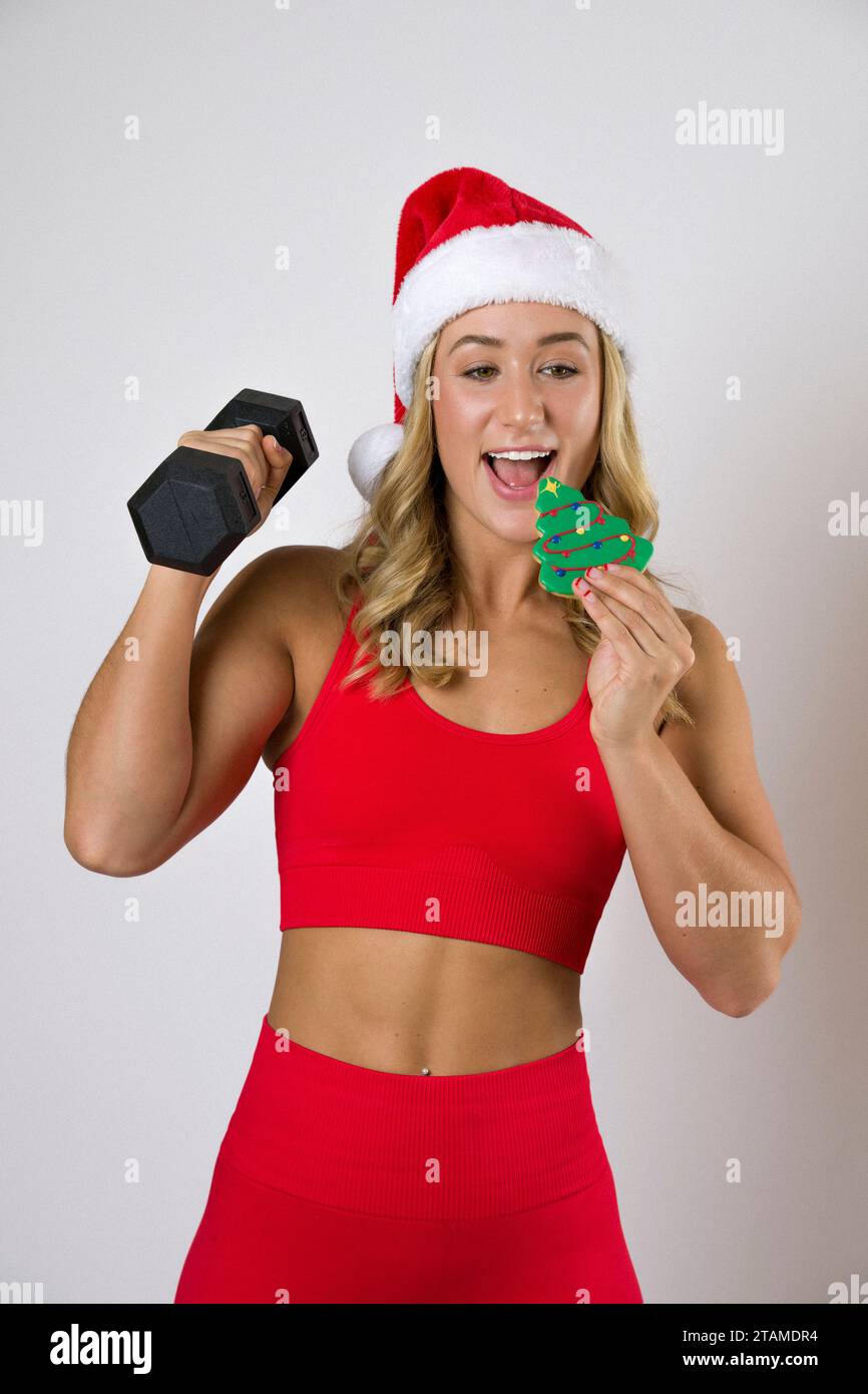 Female Bodybuilder Brawny Holding Dumbbell Eating Christmas Cookie ...