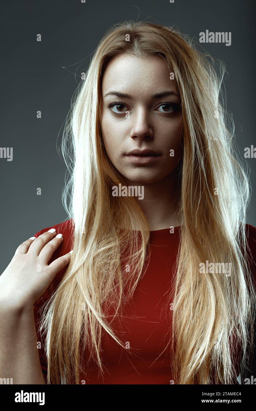 Her piercing eyes suggest deep contemplation, offset by her disheveled golden locks Stock Photo ...