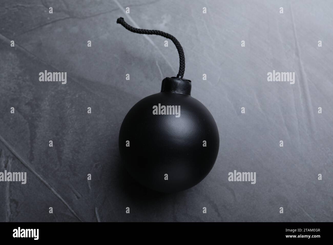 Sphere shaped bomb with burning fuse on black background, top view ...