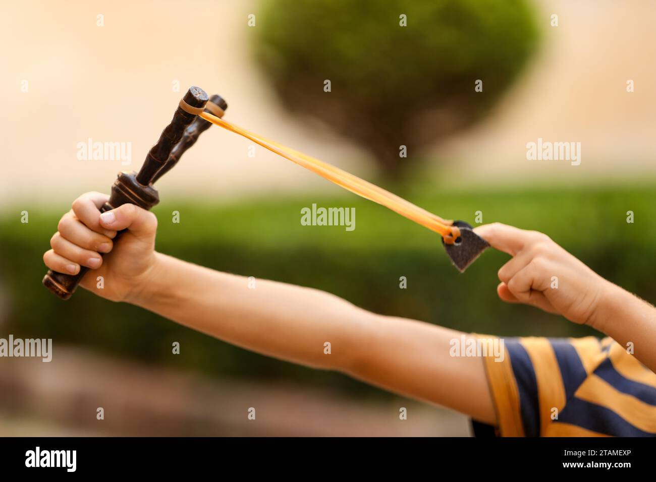 Little boy playing with slingshot outdoors, closeup Stock Photo - Alamy