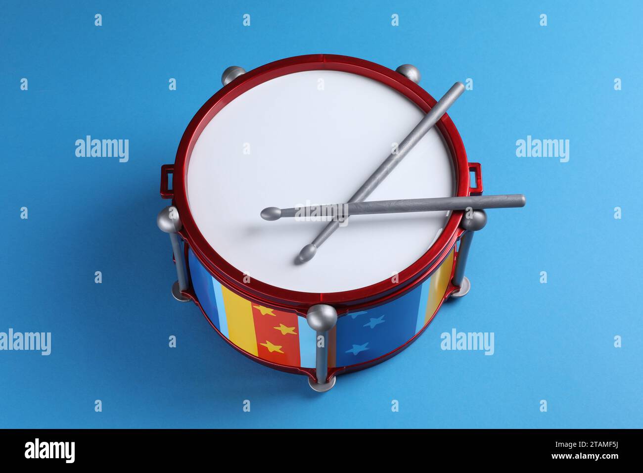 Colorful drum and sticks on light blue background. Percussion musical ...