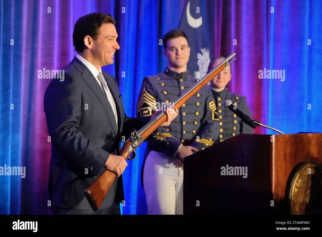 Florida Gov. Ron DeSantis, left, poses a Revolutionary War era musket ...