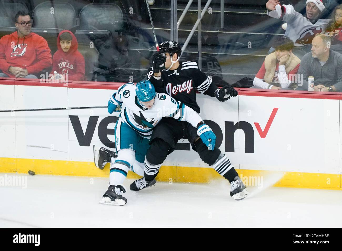 San Jose Sharks defenseman Jacob MacDonald (9) checks New Jersey Devils ...
