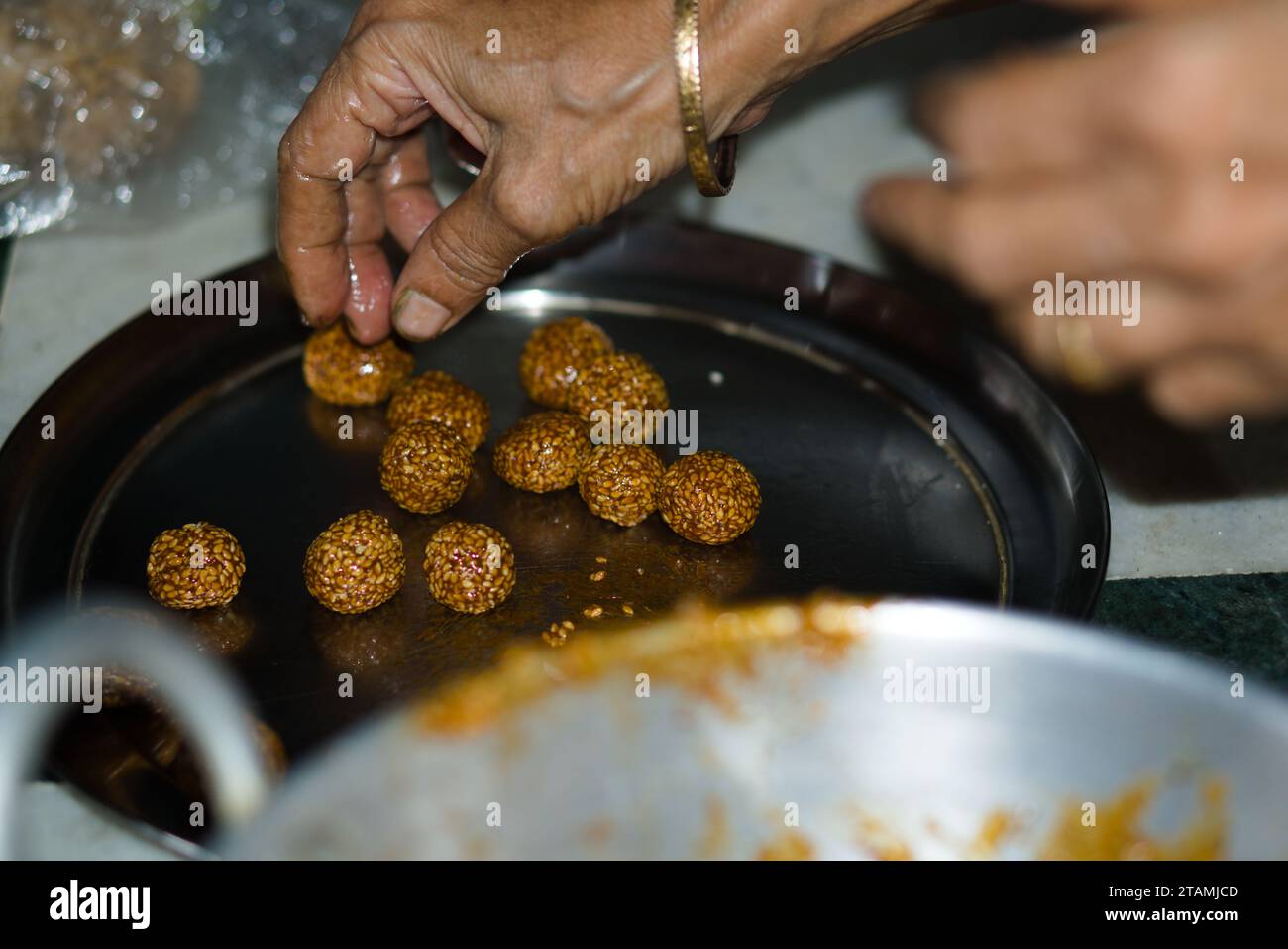 making of jaggery and seasame seed delicacy called tiler naru by hand ...