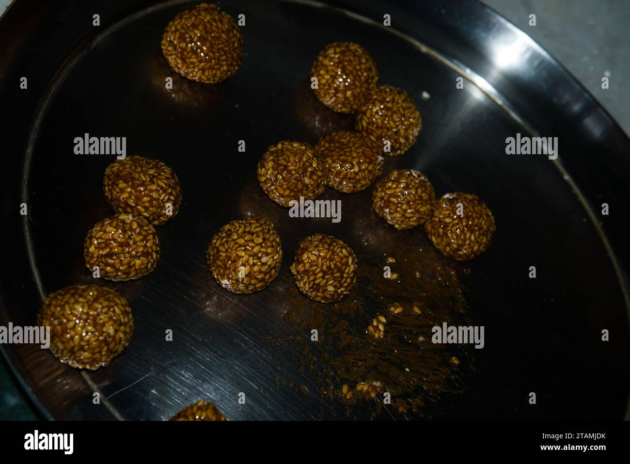 photo of a bengali sweet dish called tiler naru made of jaggery and ...