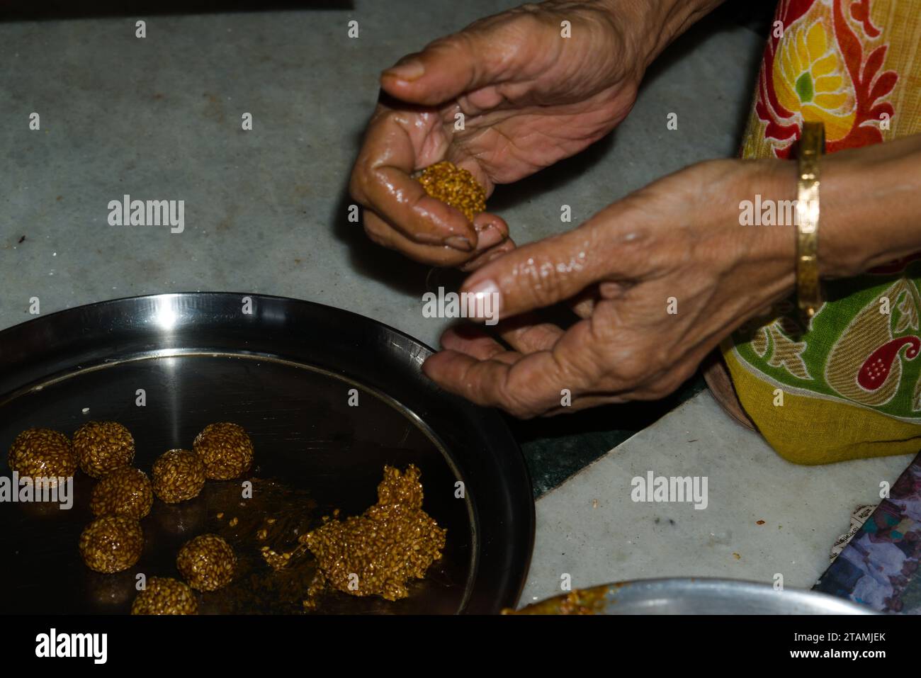making of jaggery and seasame seed delicacy called tiler naru by hand ...