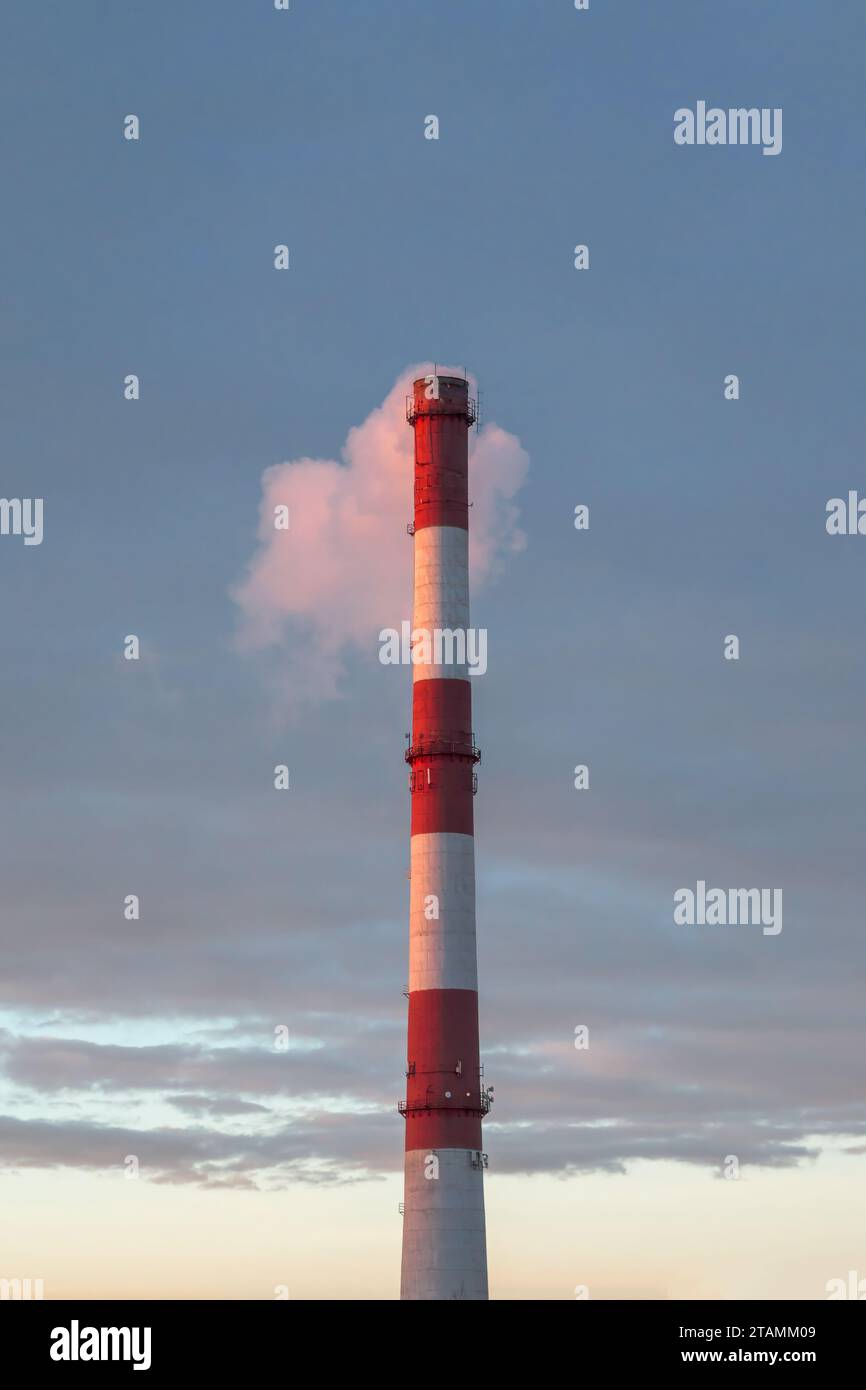Smoking pipes making clouds against sunset sky background. Dioxide air ...