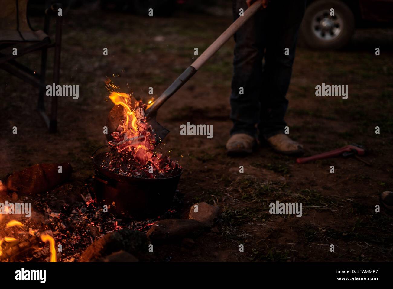 Camp Fire Outside Evening Night Shoveling Hot Coals for Dutch Oven ...
