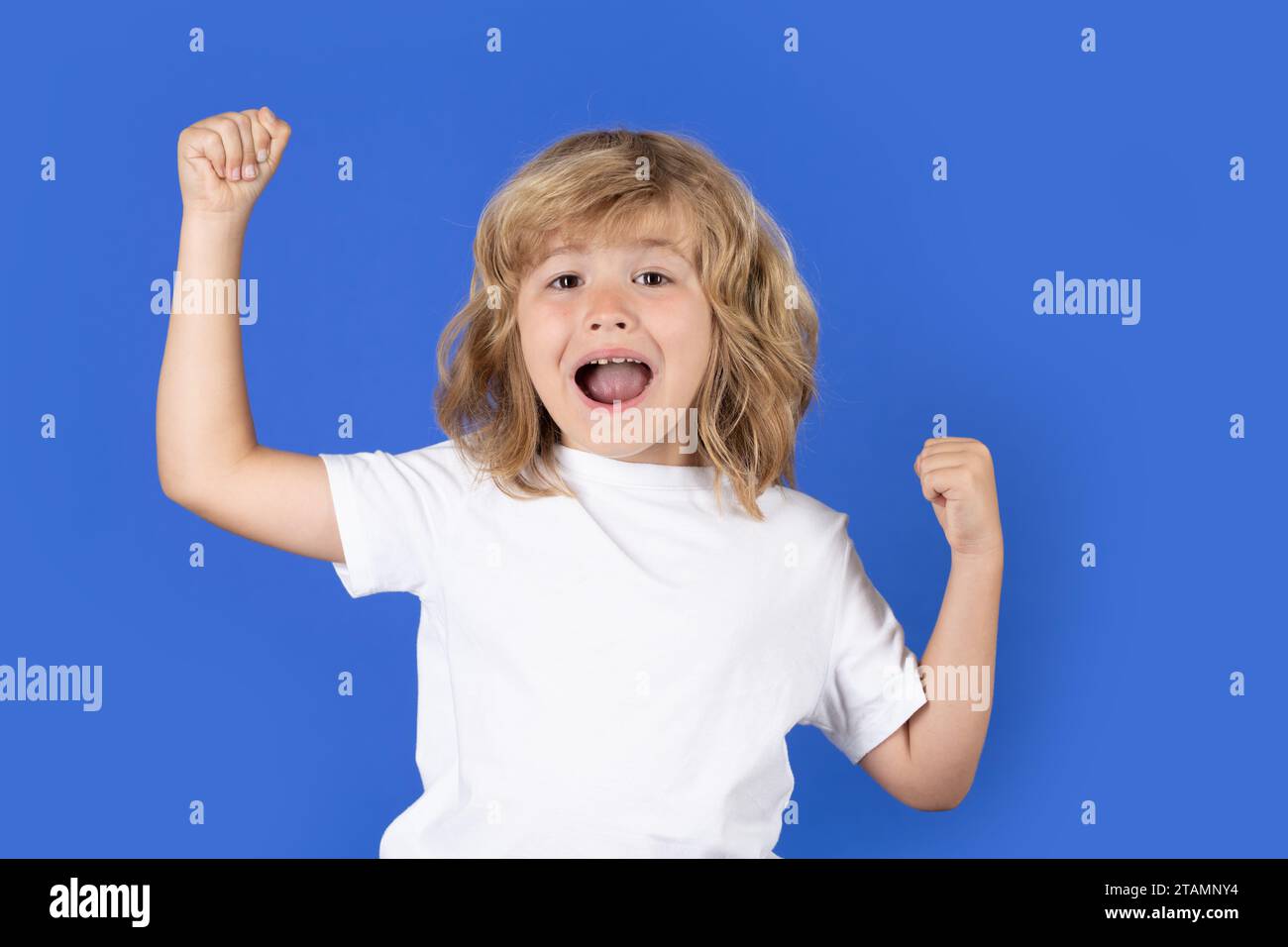 Excited kid celebrating victory on studio isolated background ...