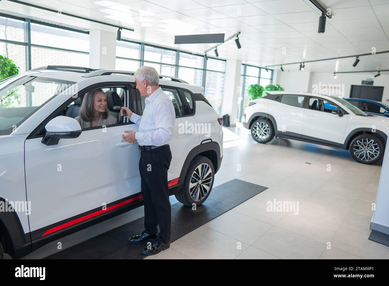 Mature woman car keys buying car hi-res stock photography and images ...