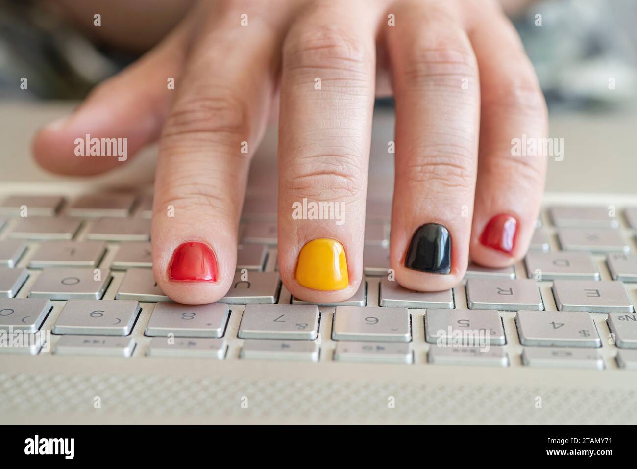 Hands on the laptop keyboard. A man with painted nails. Design of male ...