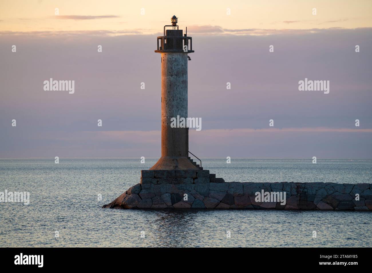 Old Finnish lighthouse Vuohensalo against the background of the April ...
