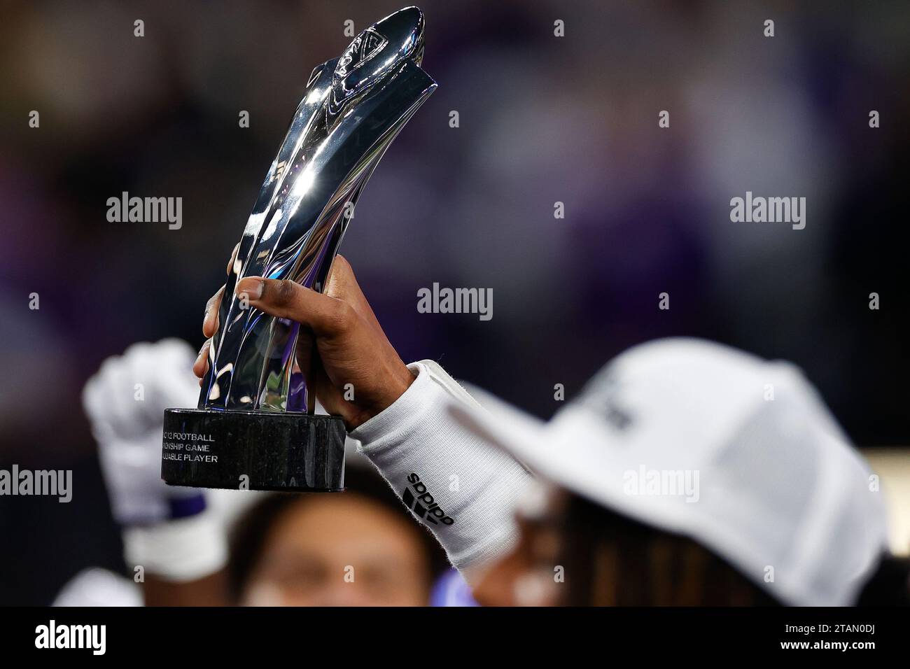 Washington quarterback Michael Penix Jr. (9) holds up the MVP trophy following an NCAA college ...