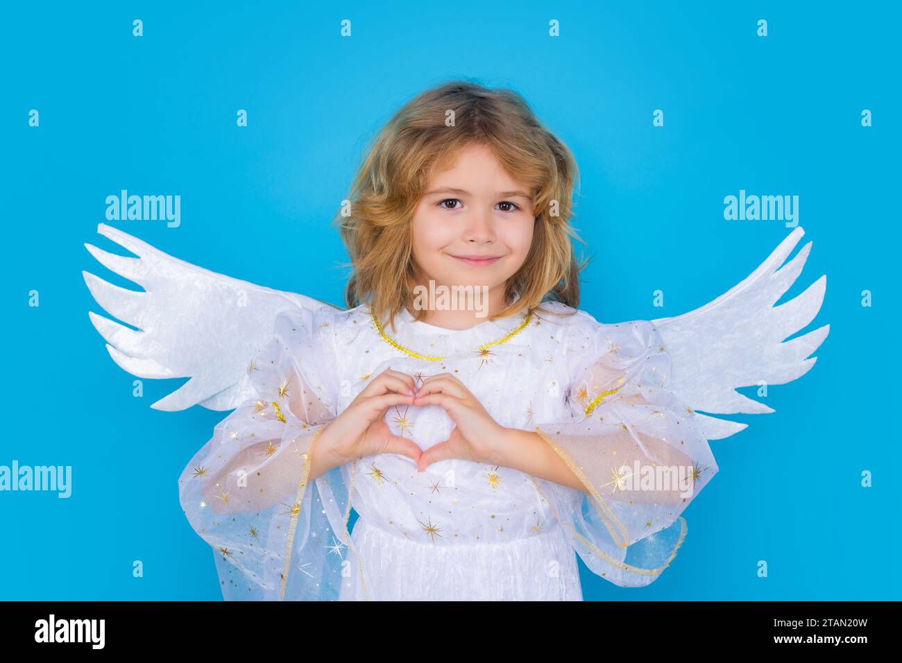 Kid wearing angel costume white dress and feather wings. Innocent child ...