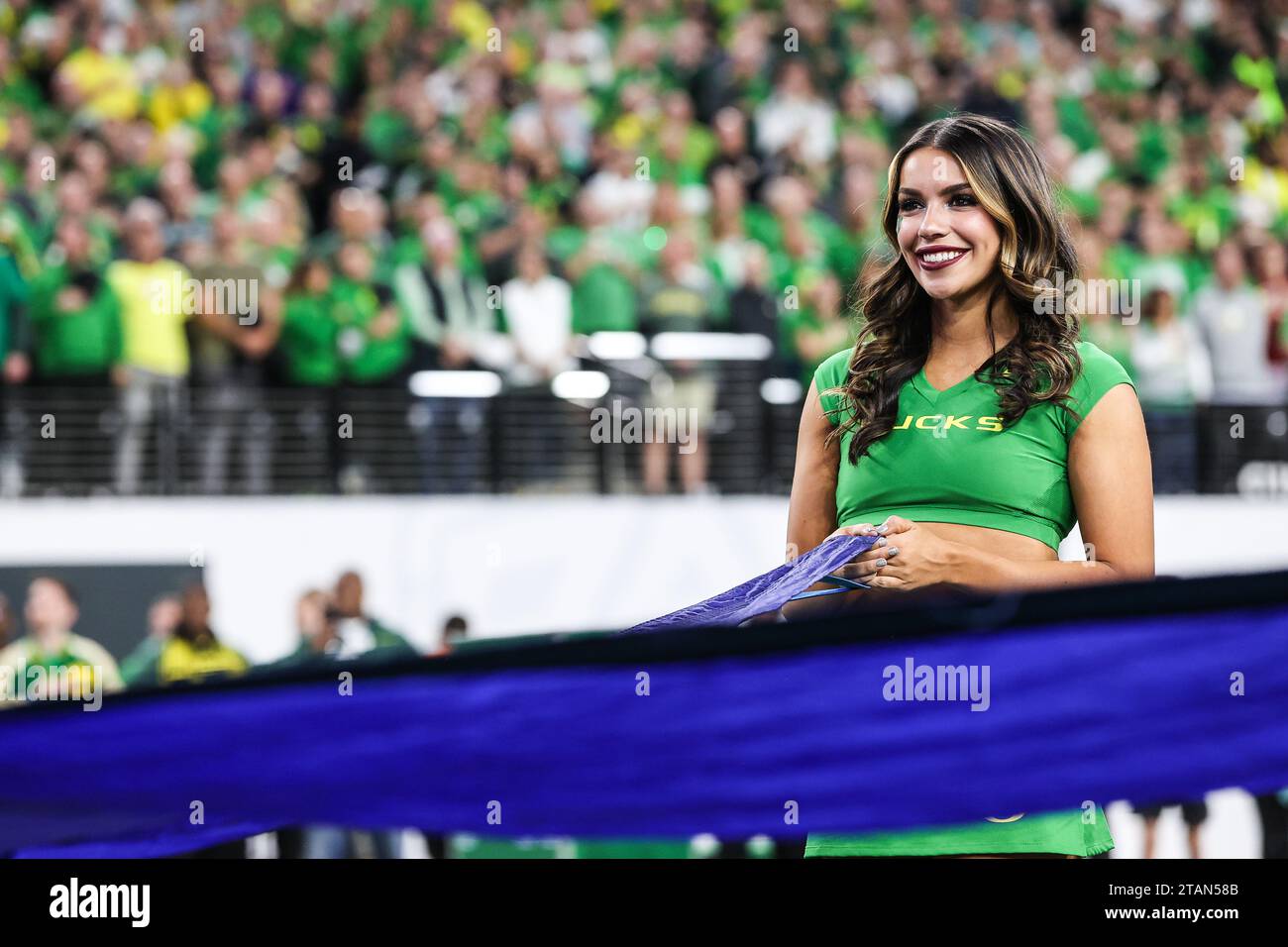 Las Vegas, NV, USA. 01st Dec, 2023. A Oregon Ducks cheerleader holds ...