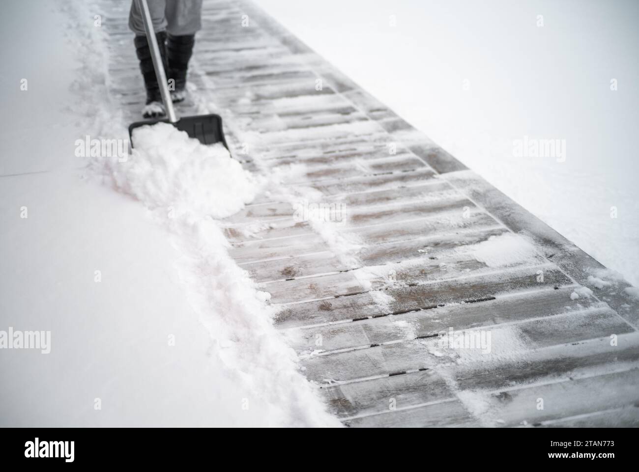 removing the snow from a hard floor of the patio, winter scene Stock ...