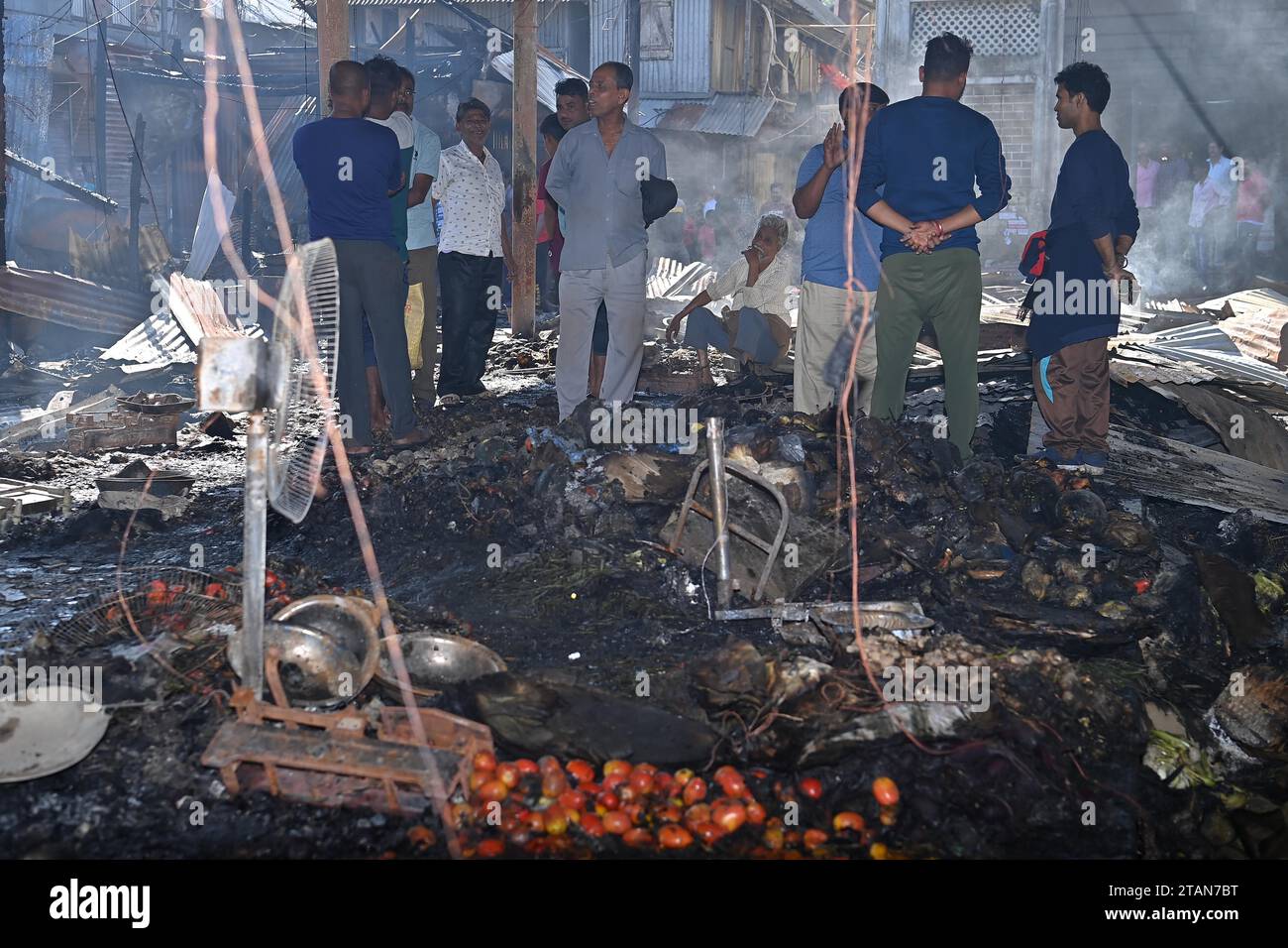Shop owners and vendors are seen in front of their burnt shops and ...