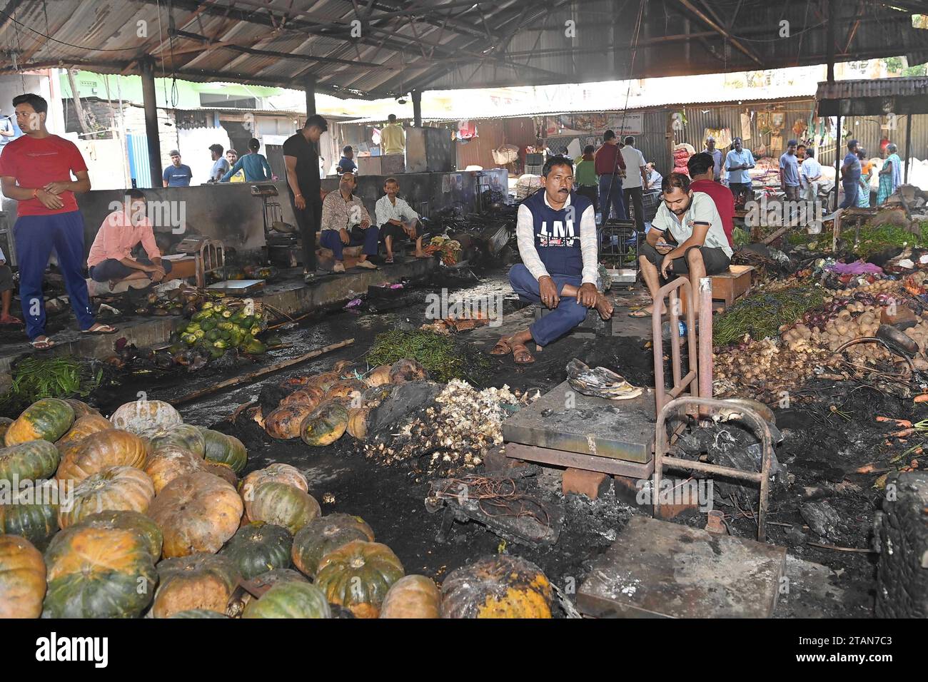 Shop owners and vendors are seen in front of their burnt shops and ...