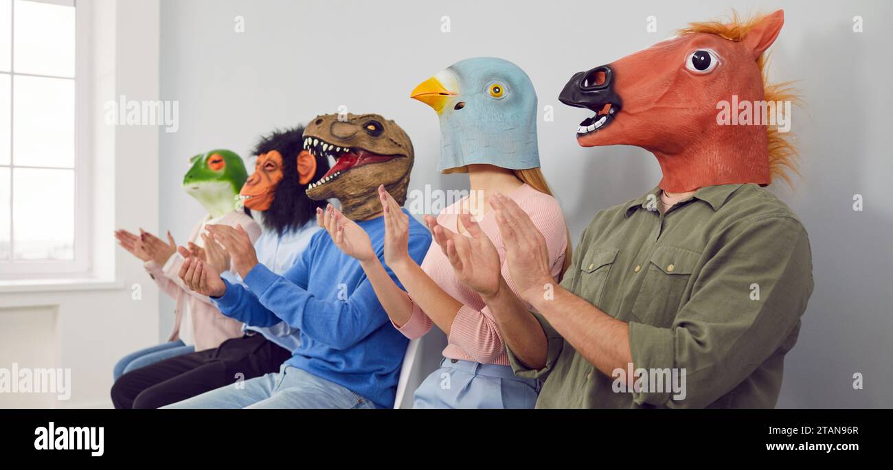 Crazy surreal audience wearing funny animal masks applauding speaker at ...
