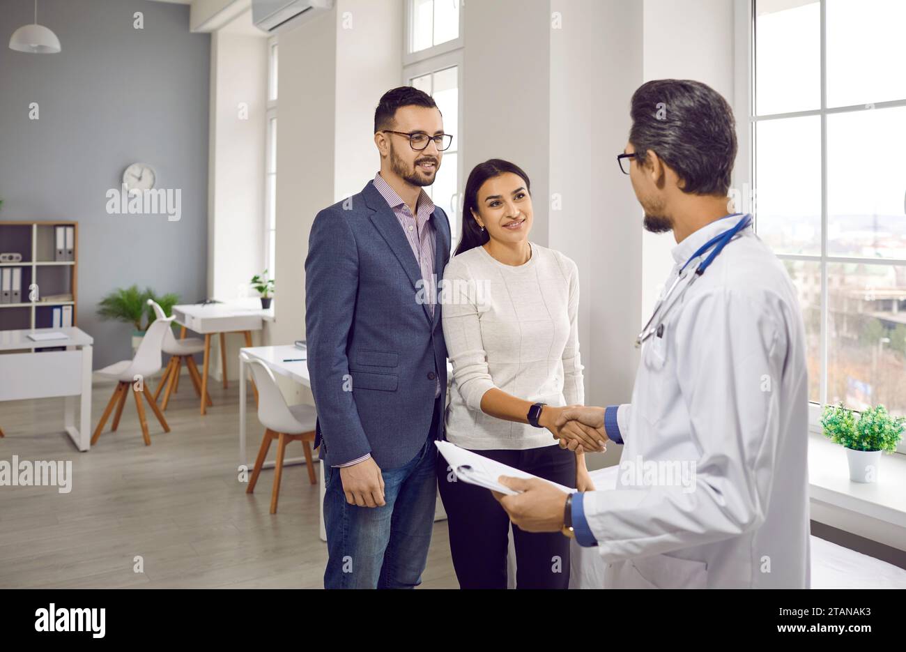 Young couple in love at a doctor's appointment in a modern office of ...