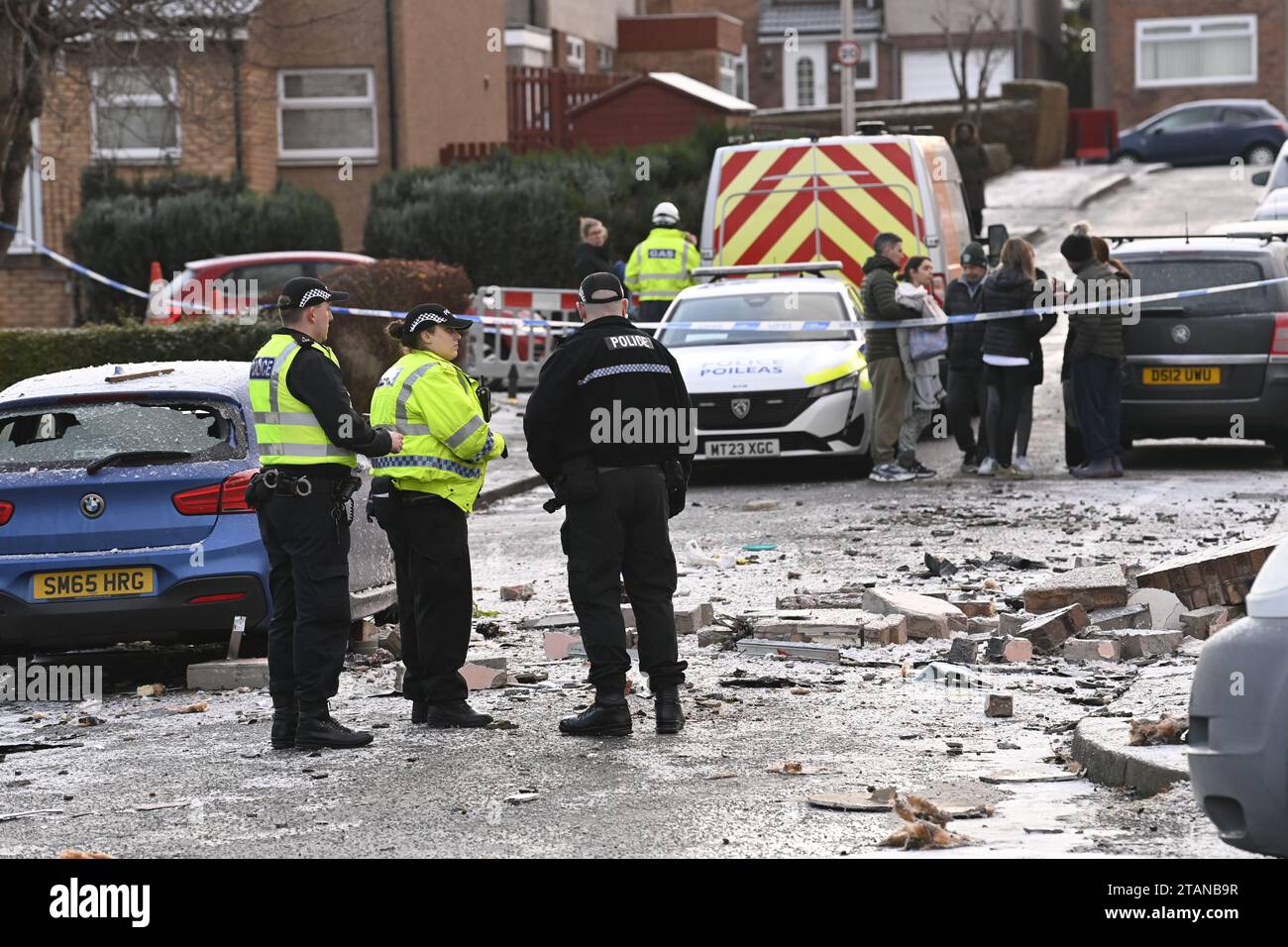 Police officers at the scene on Baberton Mains Avenue, Edinburgh, after ...