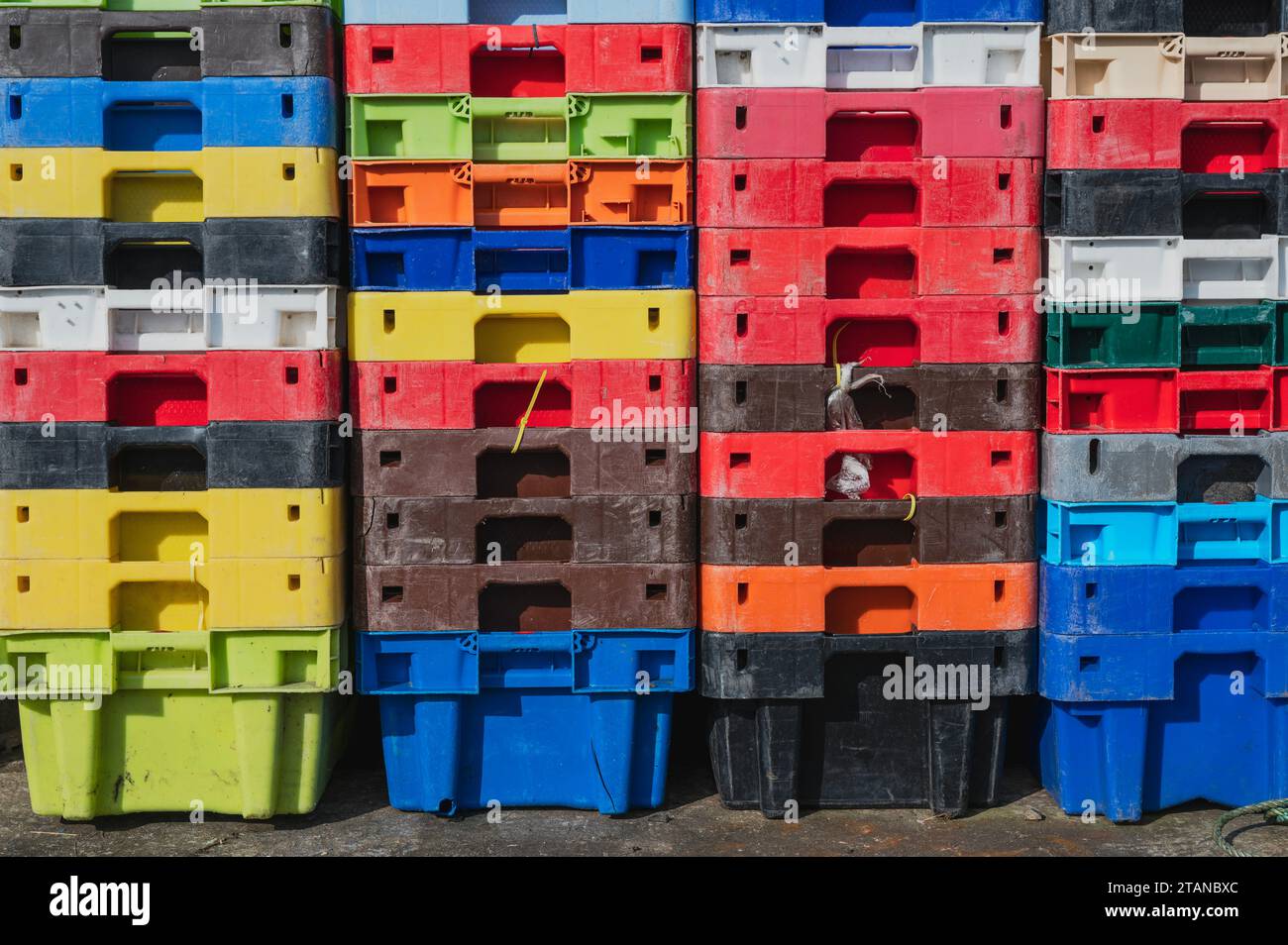 A group of colourful stackable fishing crates on the Isle of Mull ...