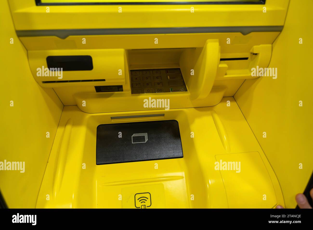 A close-up shot of a modern ATM machine with a digital push-button ...