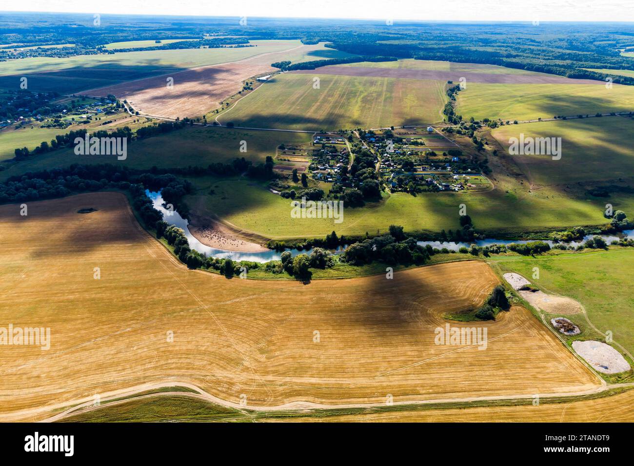 Aerial photography of a sparsely populated flat area with a river ...
