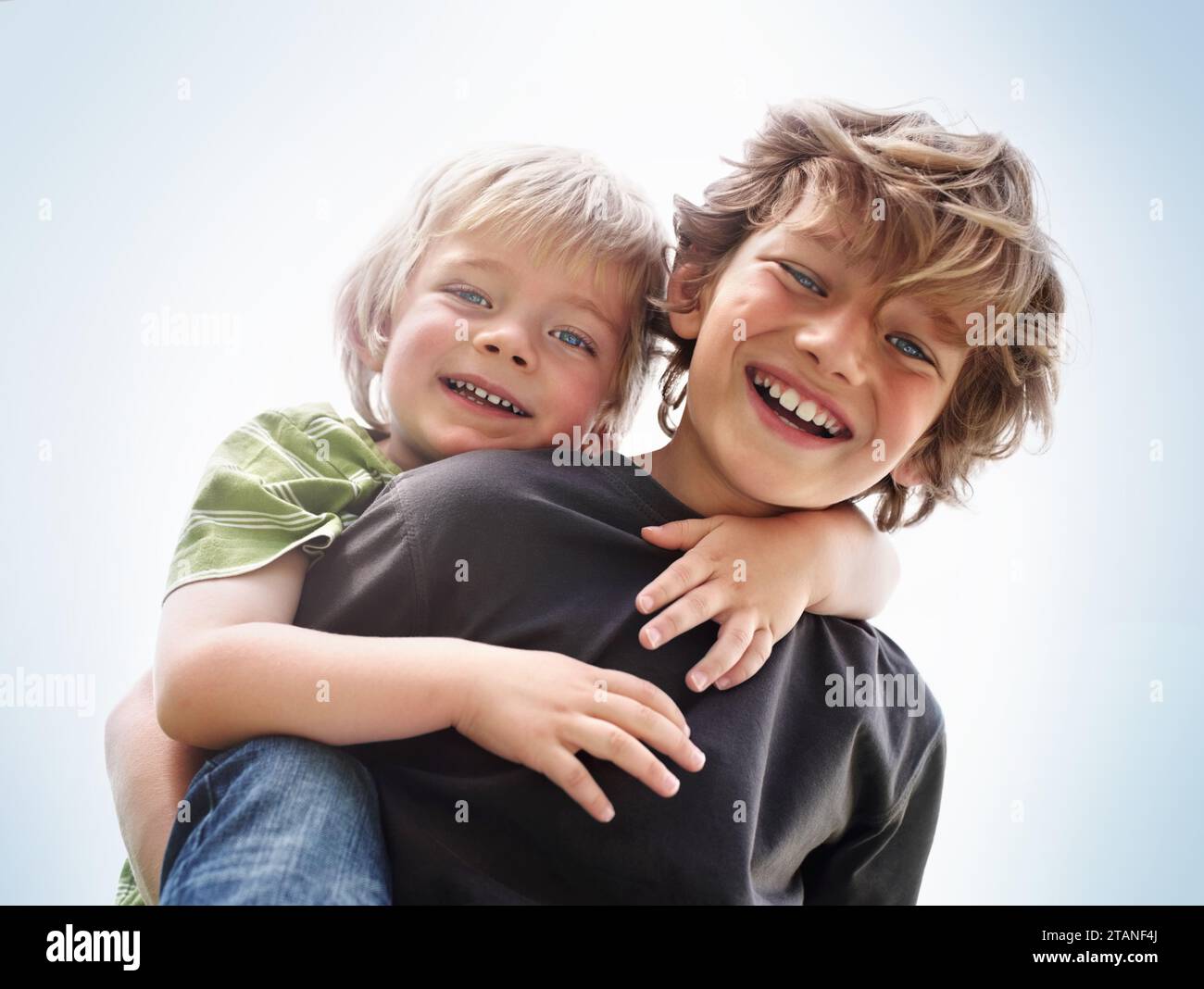 Siblings, boy and brother or portrait with piggyback for bonding ...