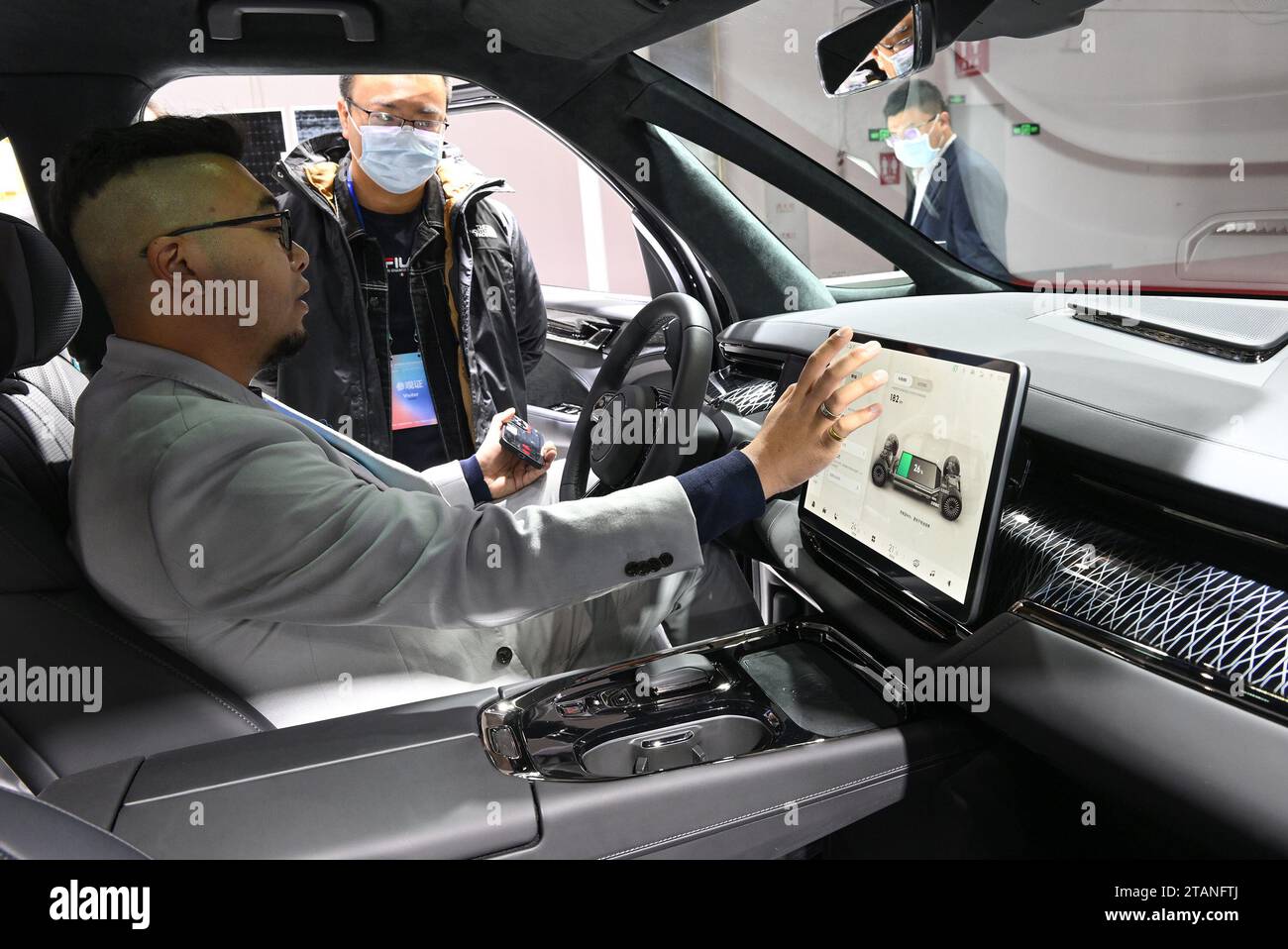 Beijing, China. 1st Dec, 2023. Visitors learn about a new energy ...