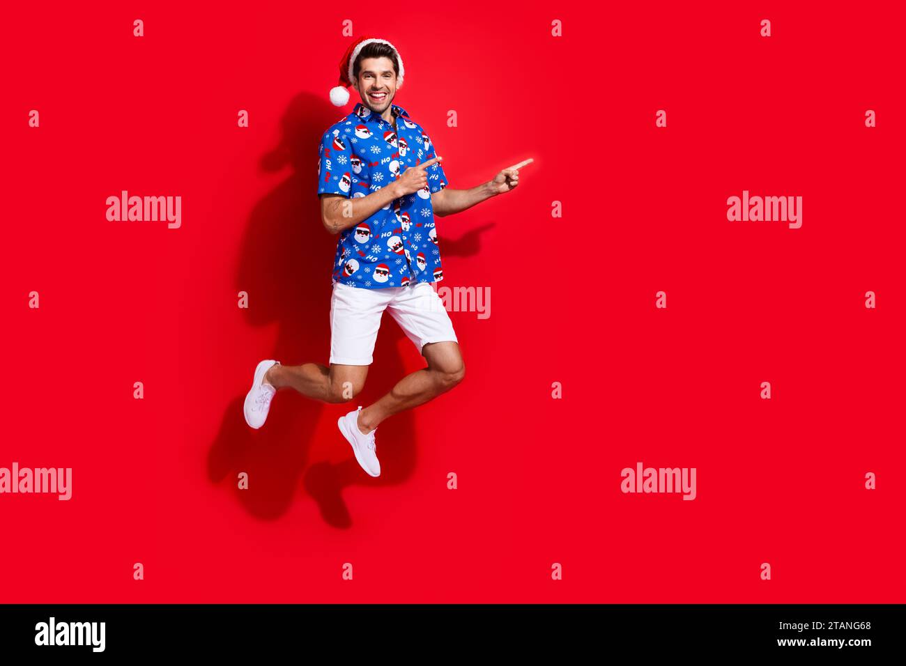 Full length photo of nice young male point empty space jumping dressed ...