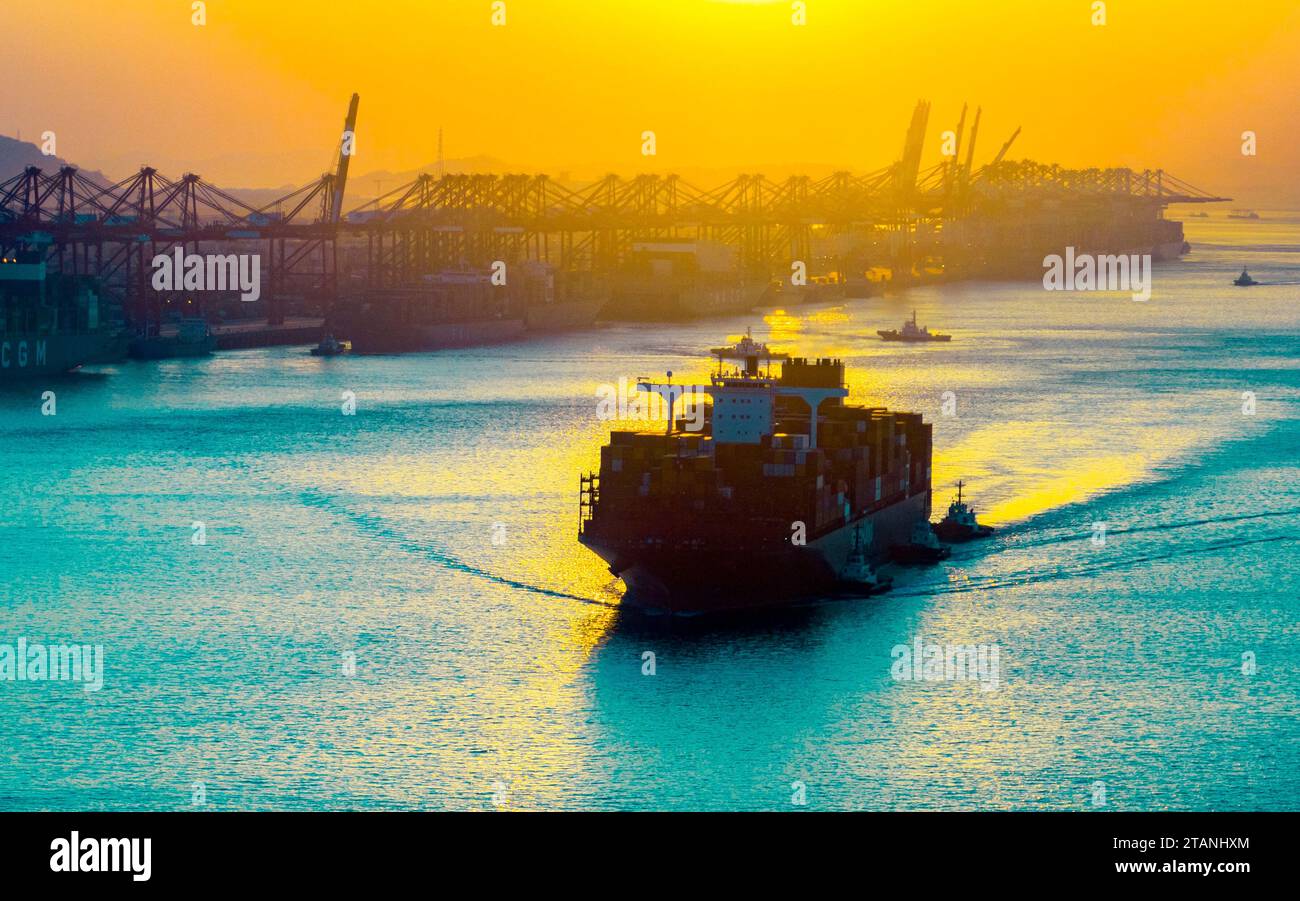 SHANGHAI, CHINA - DECEMBER 2, 2023 - A container ship prepares to dock ...