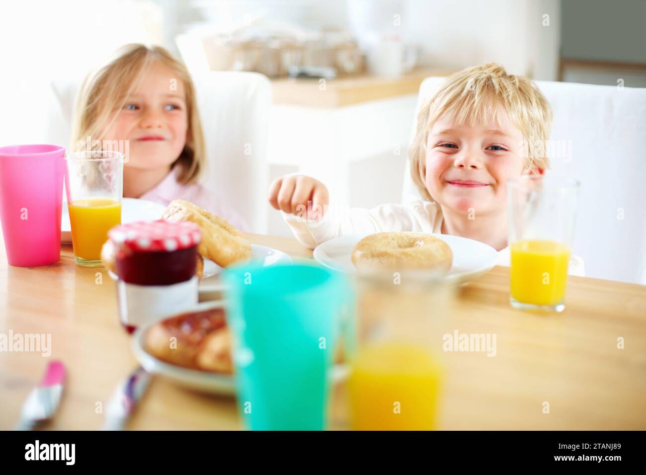 Smile, kitchen and children eating breakfast together for healthy ...