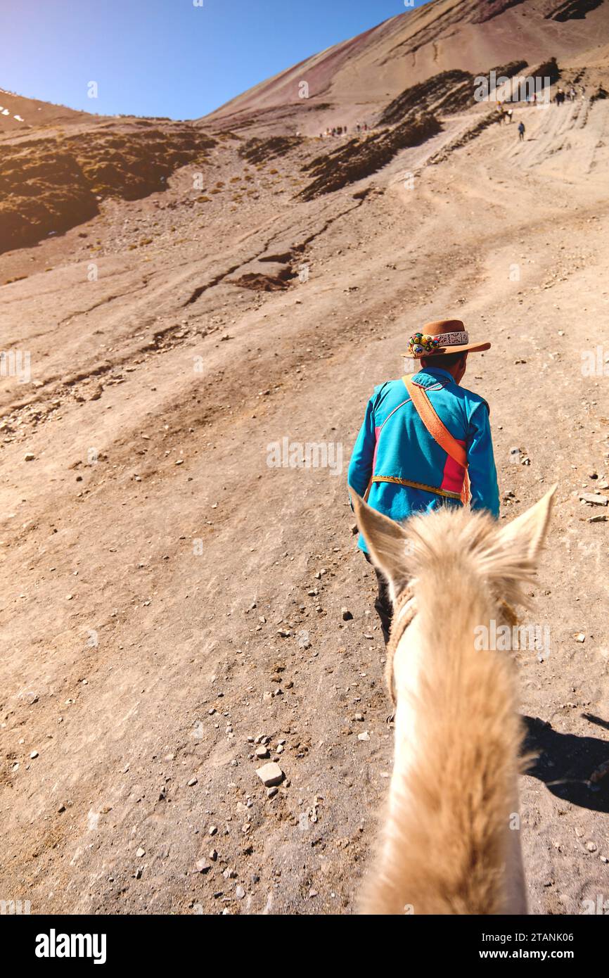 Peruvian Andean man wearing traditional colorful clothing walking up ...