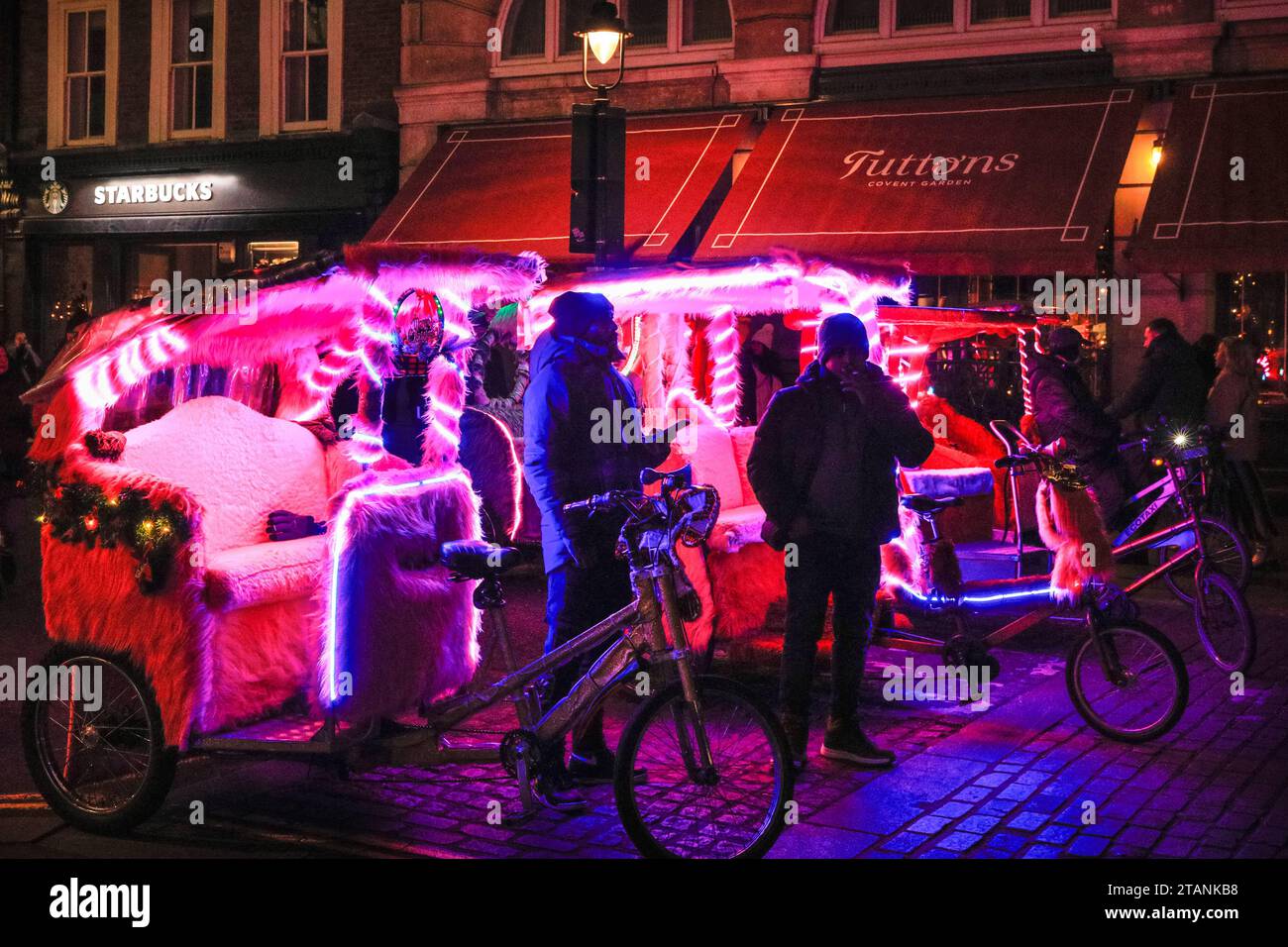 Velo taxi drivers (also called cycle cabs or bike cabs) have decorated ...