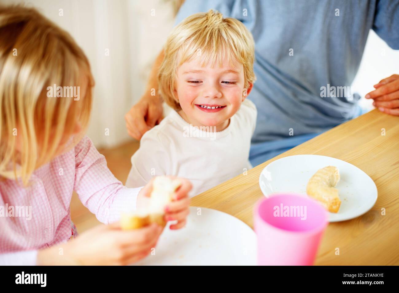 Happy, kitchen and children eating breakfast together for healthy ...