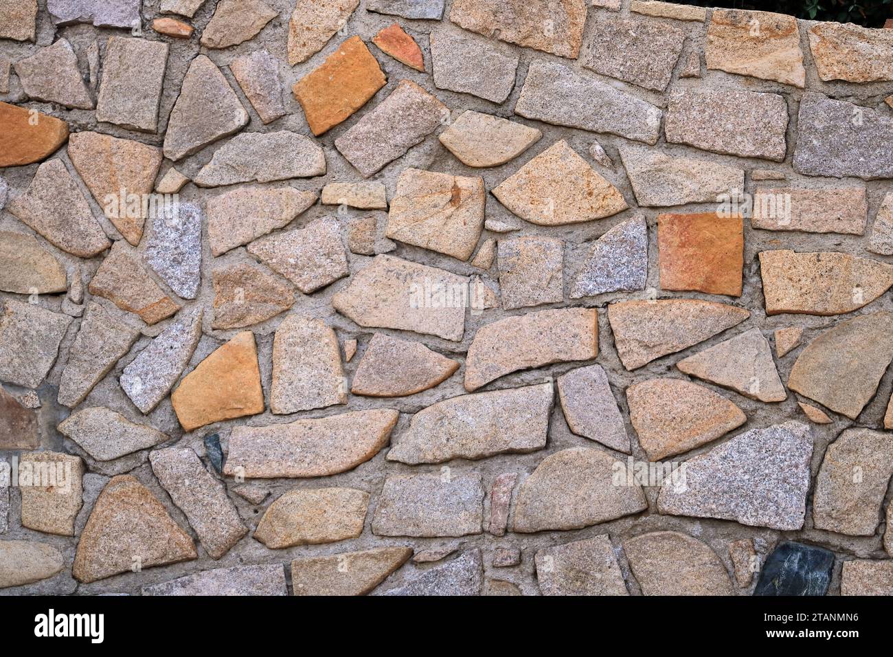 yellow beige natural stone wall of different sized stones, traditional ...