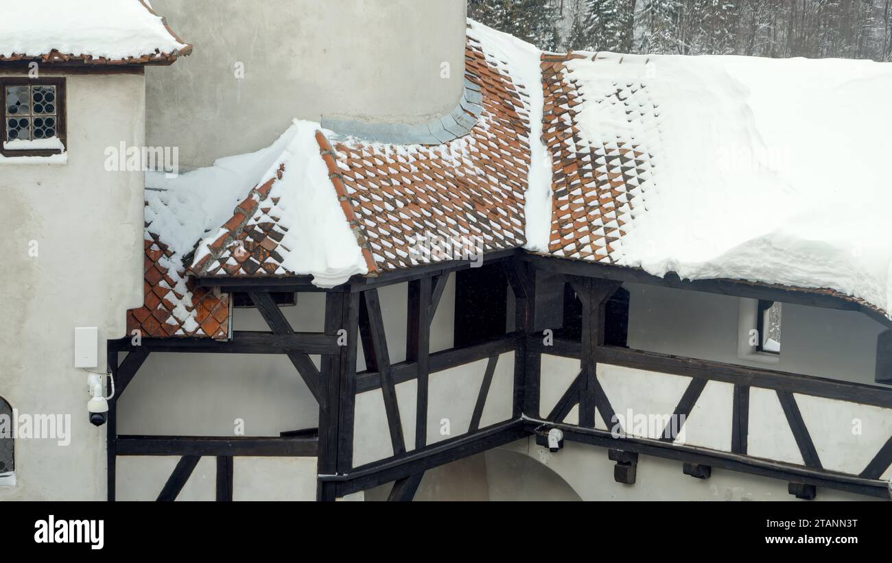 Snow blown from red roofs of the medieval castle at snow blizzard Stock ...