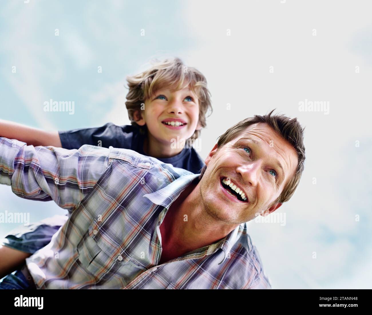 Father, son and smile outdoor with piggyback for bonding, relationship ...